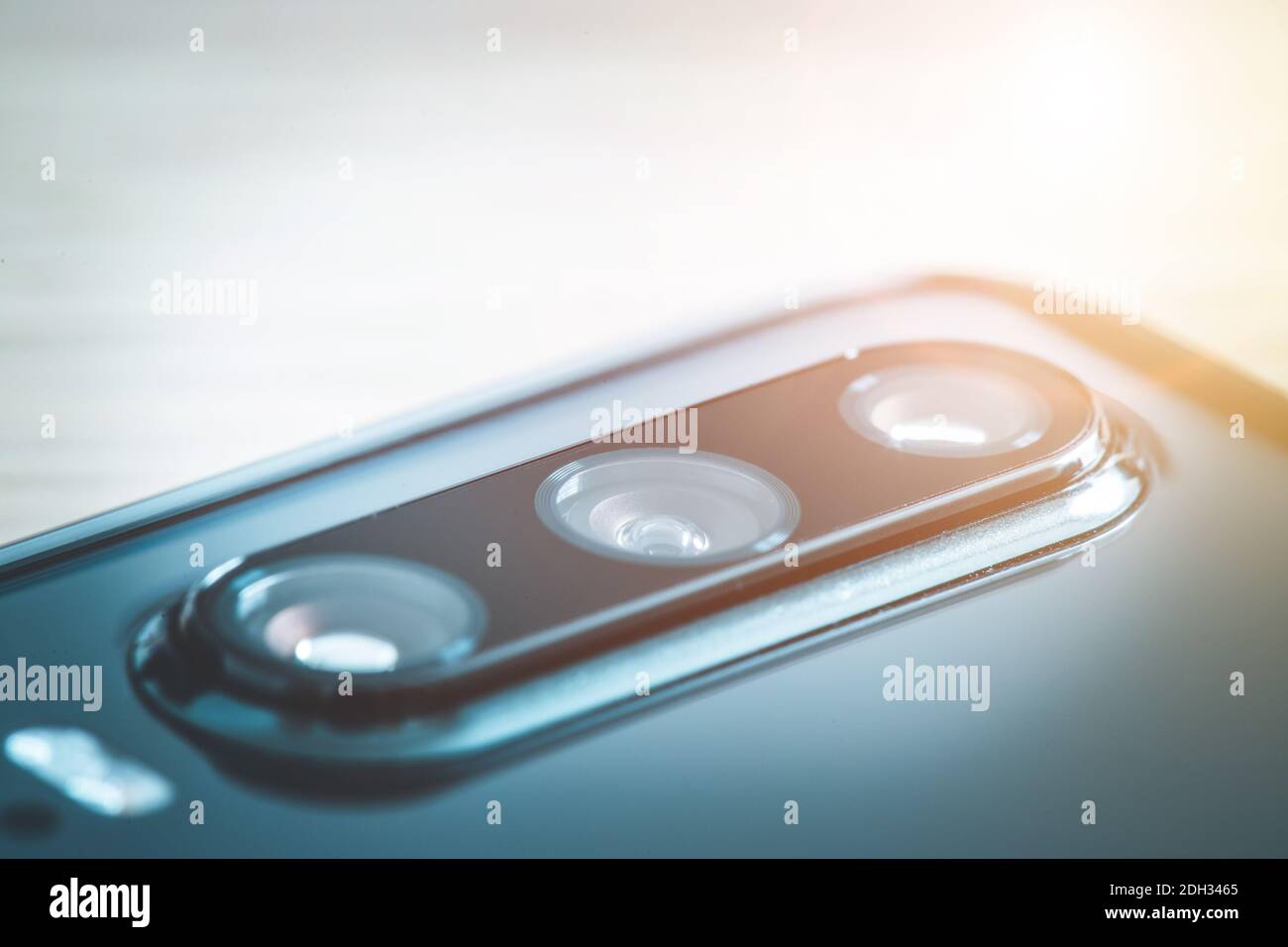 Mobile phone with triple lens. Camera innovation Stock Photo - Alamy