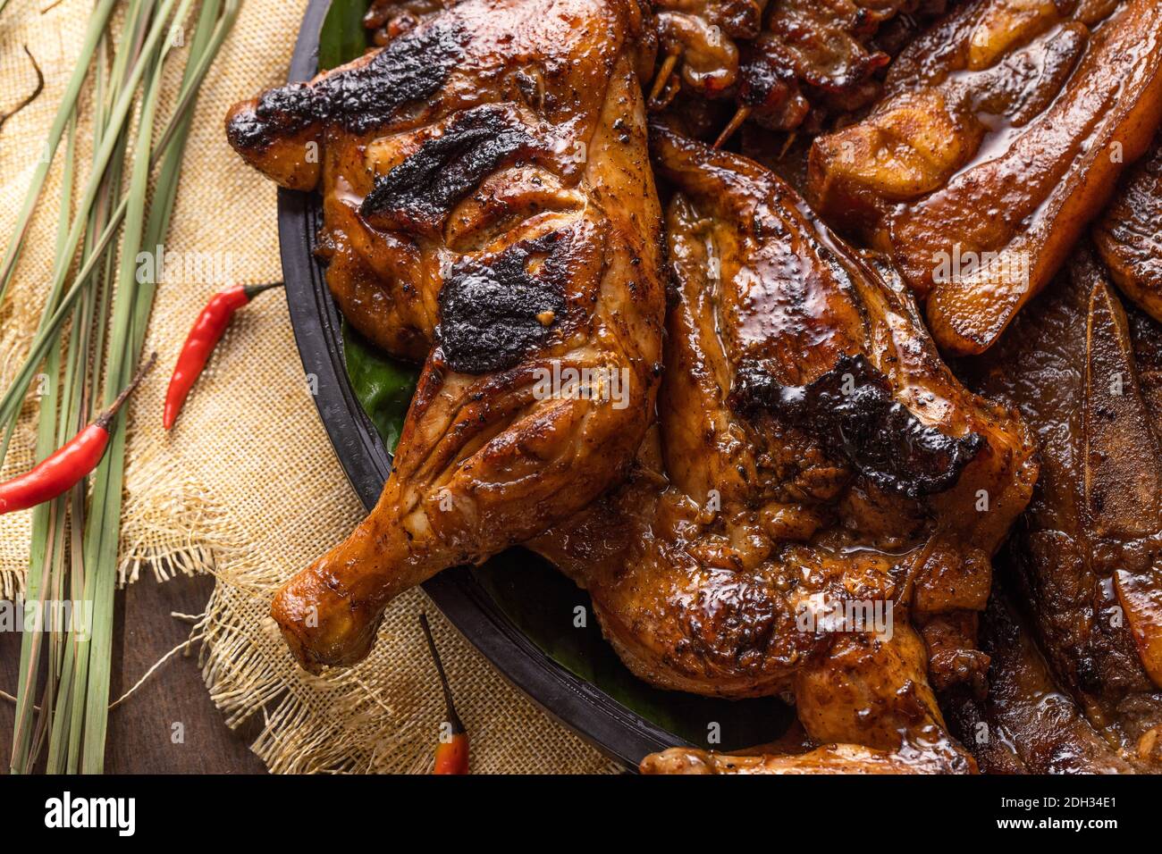 A top view of a grilled chicken served with delicious pork and kebab ...