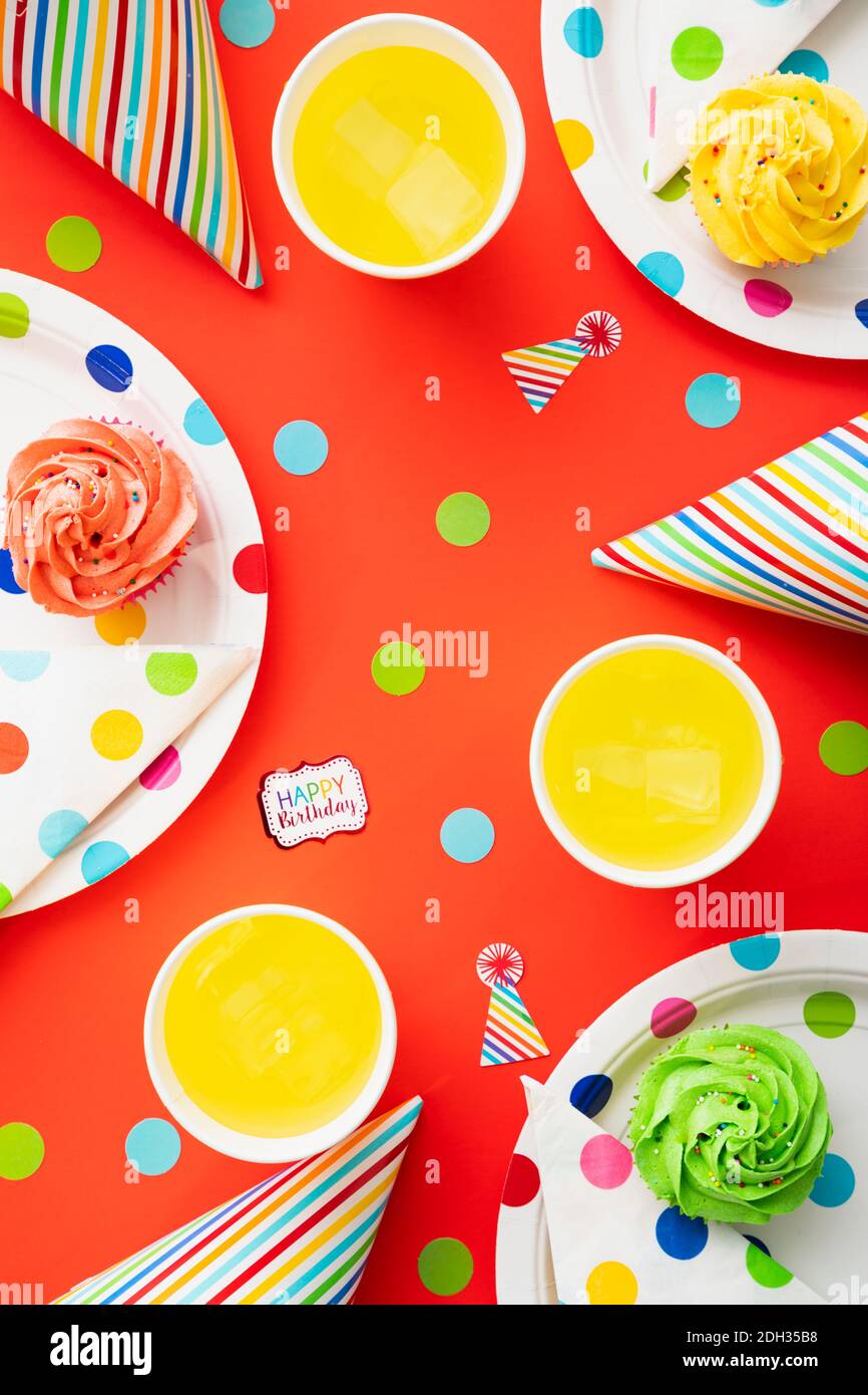 Colorful birthday party setup with cupcakes and drinks on a polka dot ...