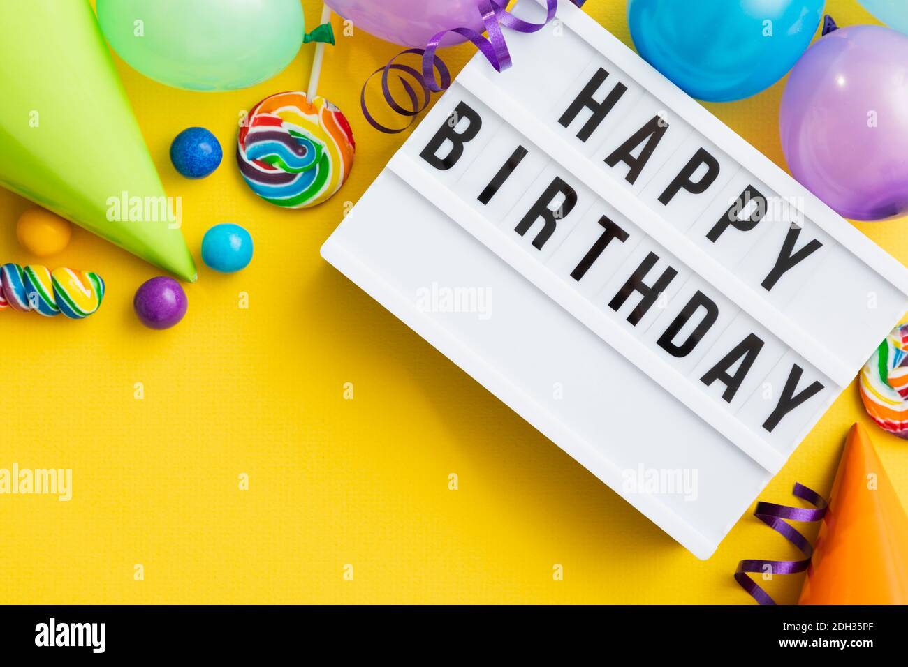 Colorful birthday celebration setup with decorations, sweets, and ...