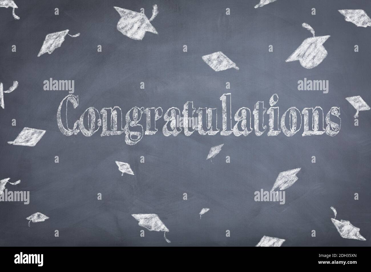 Congratulations message with graduation caps on a chalkboard background ...