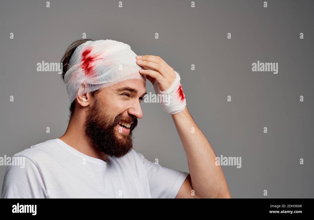 man with bandaged head and arm blood treatment injury hospital problem ...