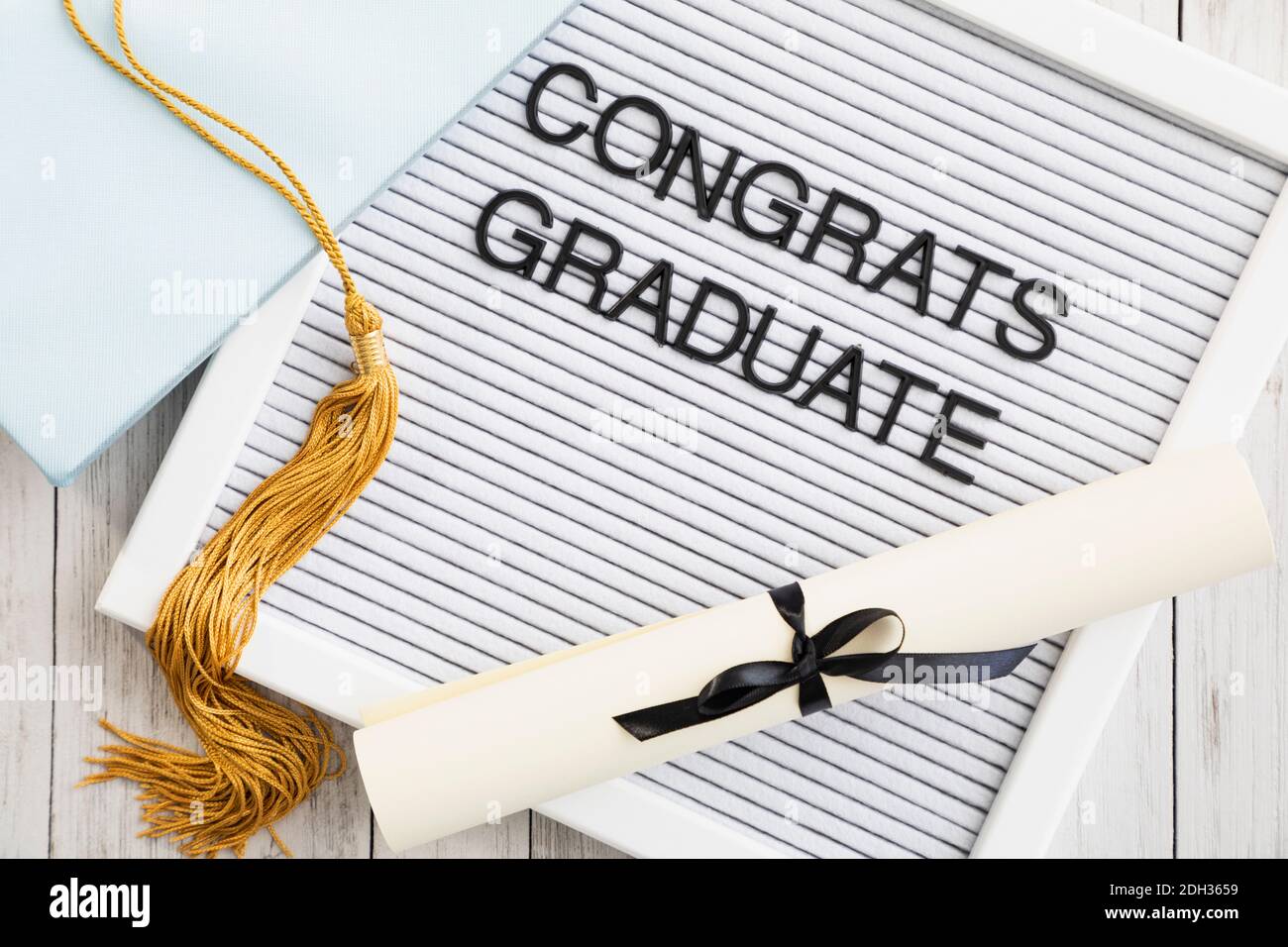 Celebrating graduation with a diploma, cap, and congratulatory message ...