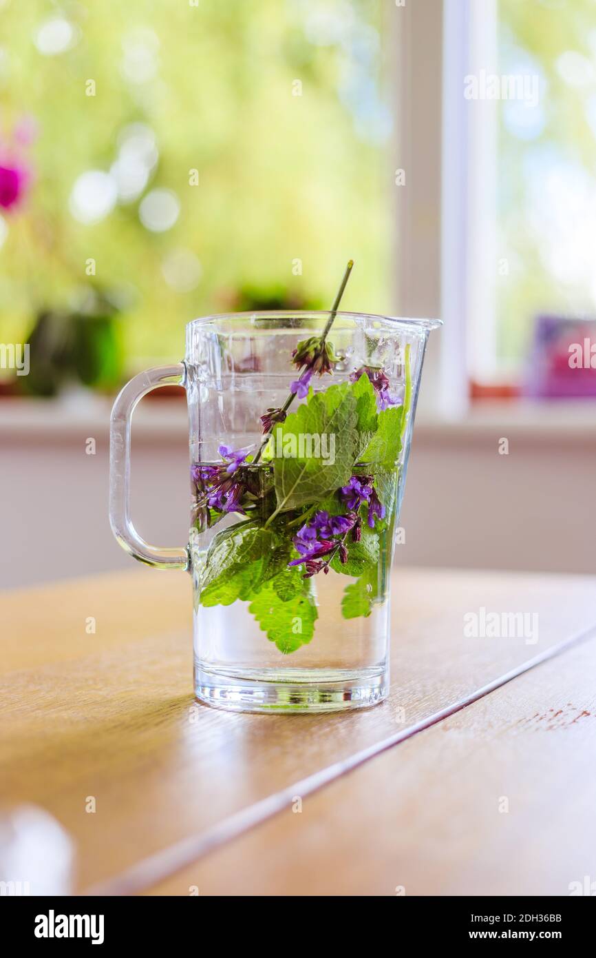 Cold refreshing water jar in summer: Tasty lemonade with herbs, multi ...