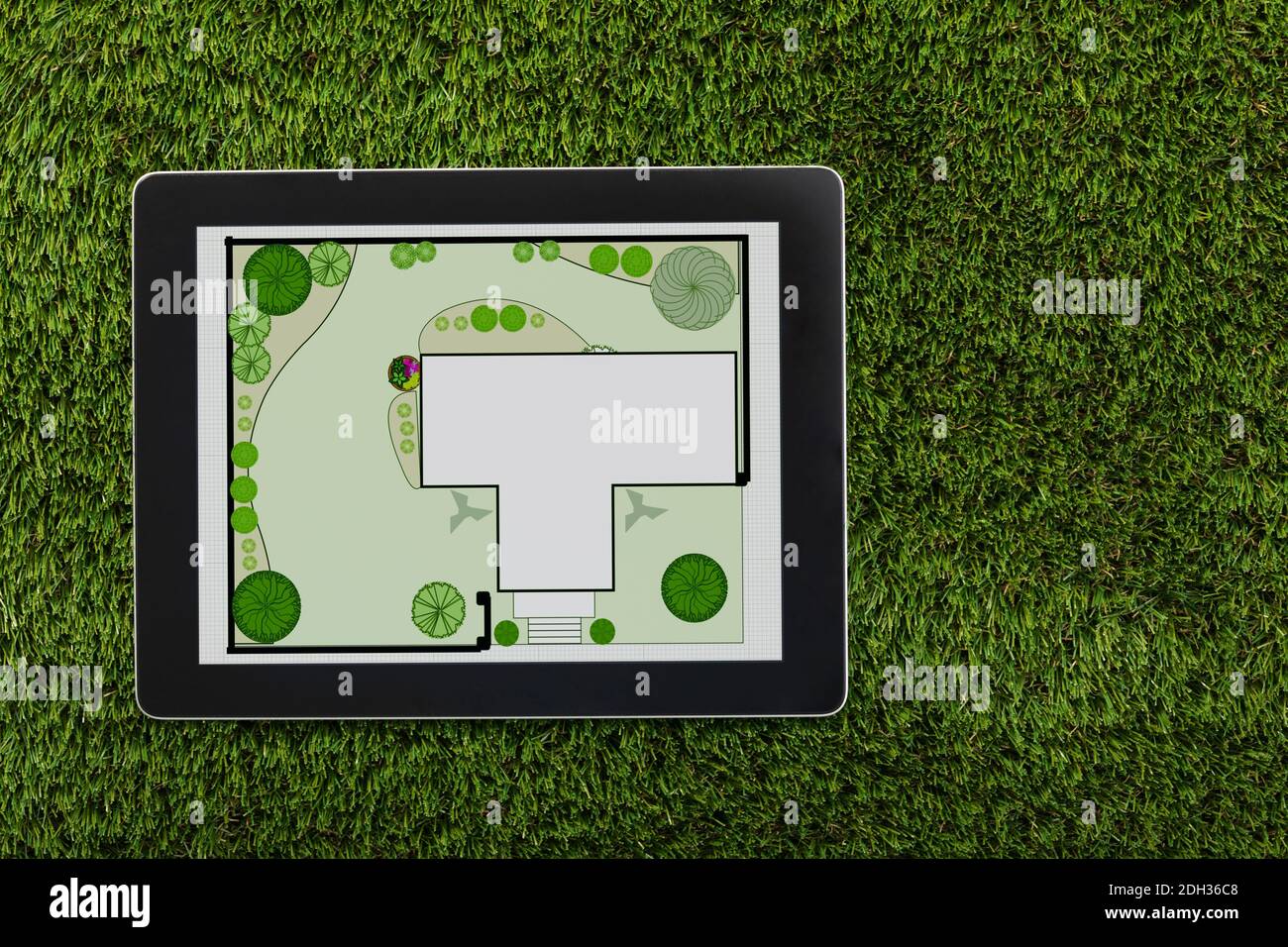 Landscape design plan displayed on tablet over green grass ...
