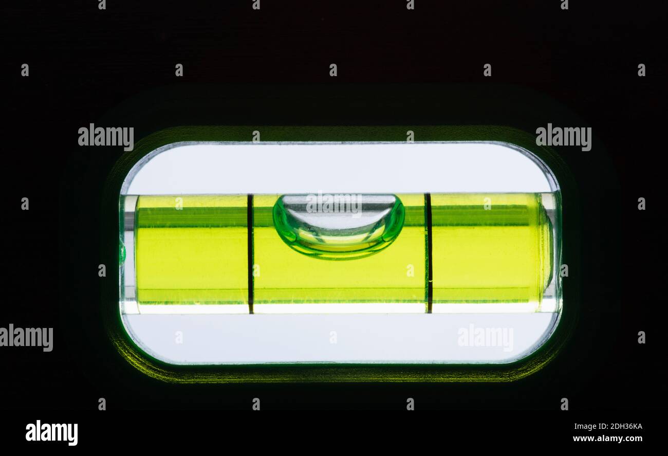 Tool measuring levelness with clear liquid and air bubble in calibrated ...