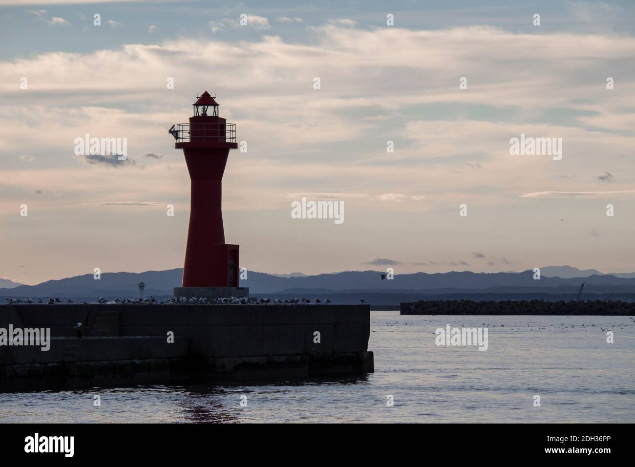 The dim sky at dusk and the lighthouse at Kushiro Port Stock Photo - Alamy