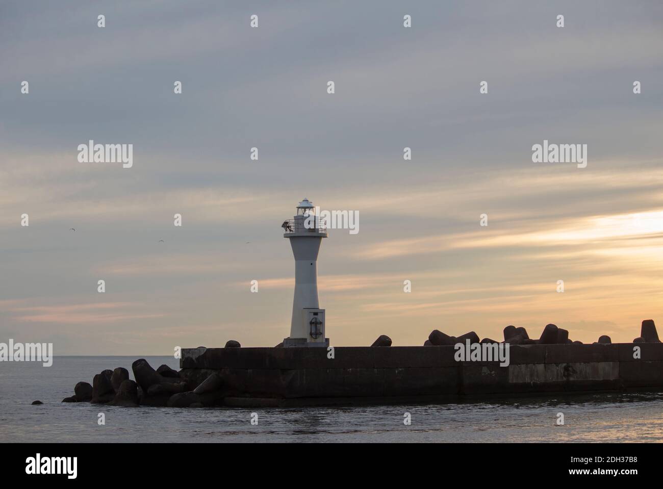 The dim sky at dusk and the lighthouse at Kushiro Port Stock Photo - Alamy