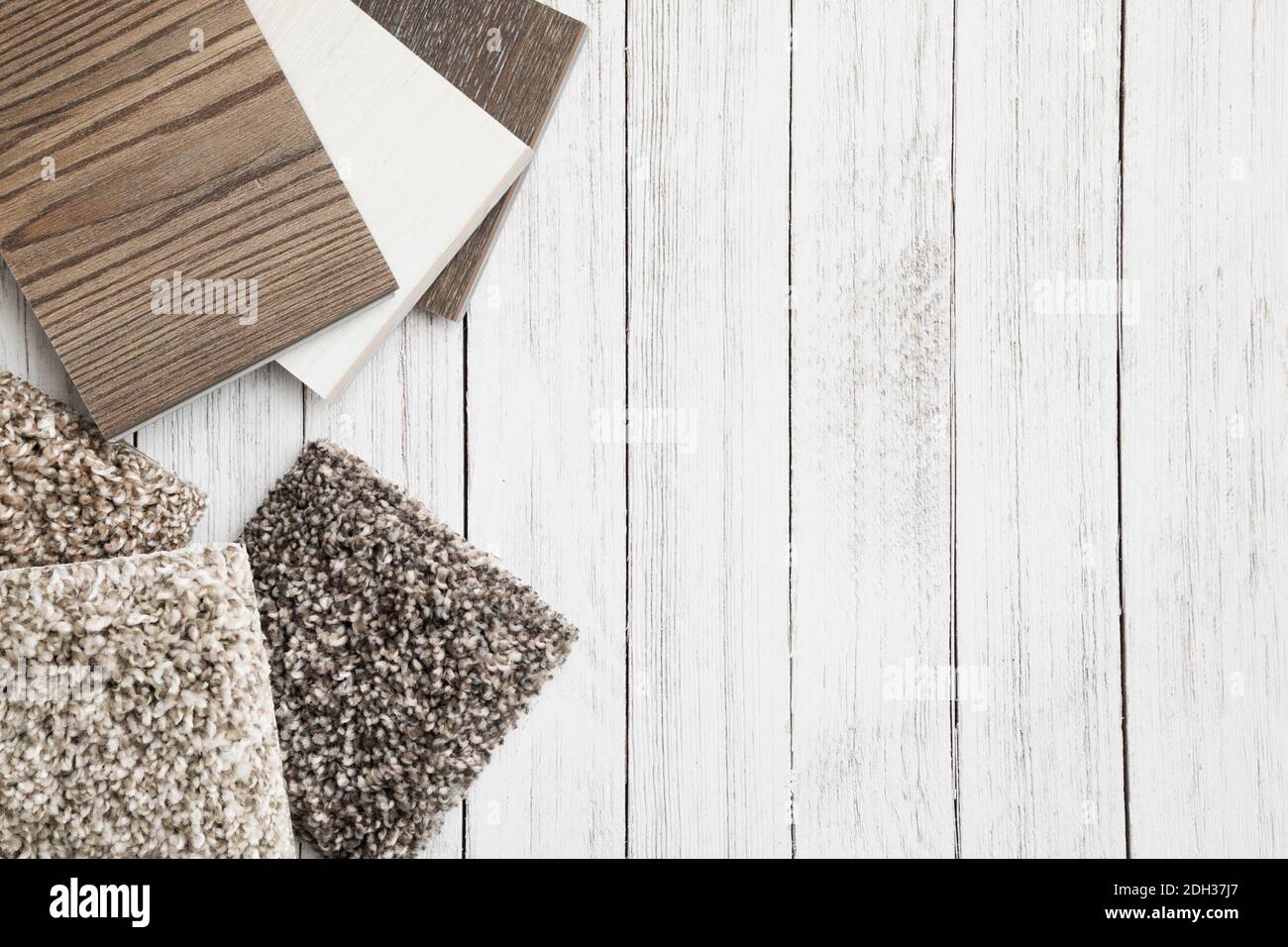 Variety of flooring samples displayed on a wooden surface for interior ...