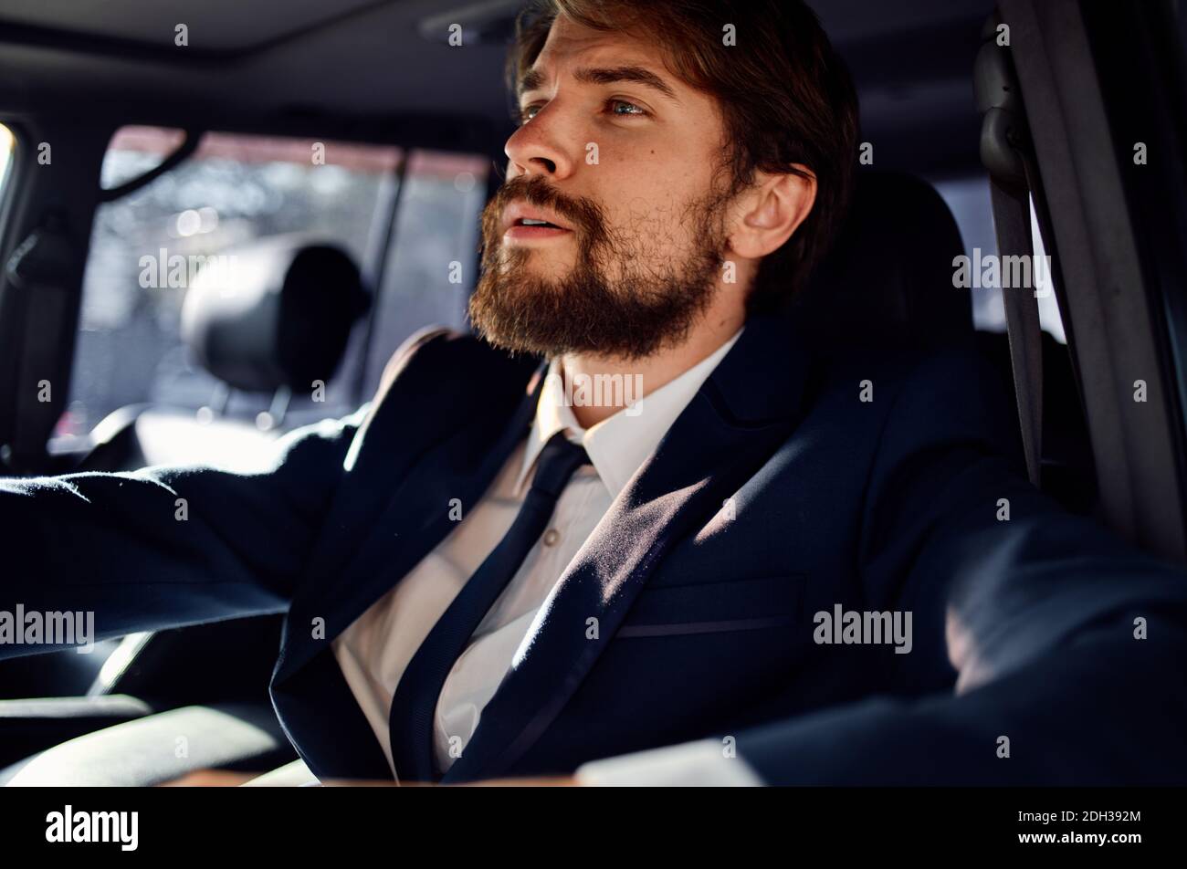 successful young man driving a car in a suit trip lifestyle Stock Photo ...