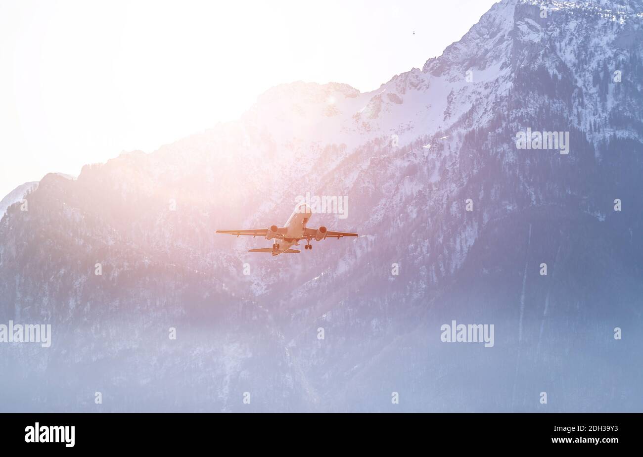 Airplane scenery: take off from airport, mountain range in the alps ...