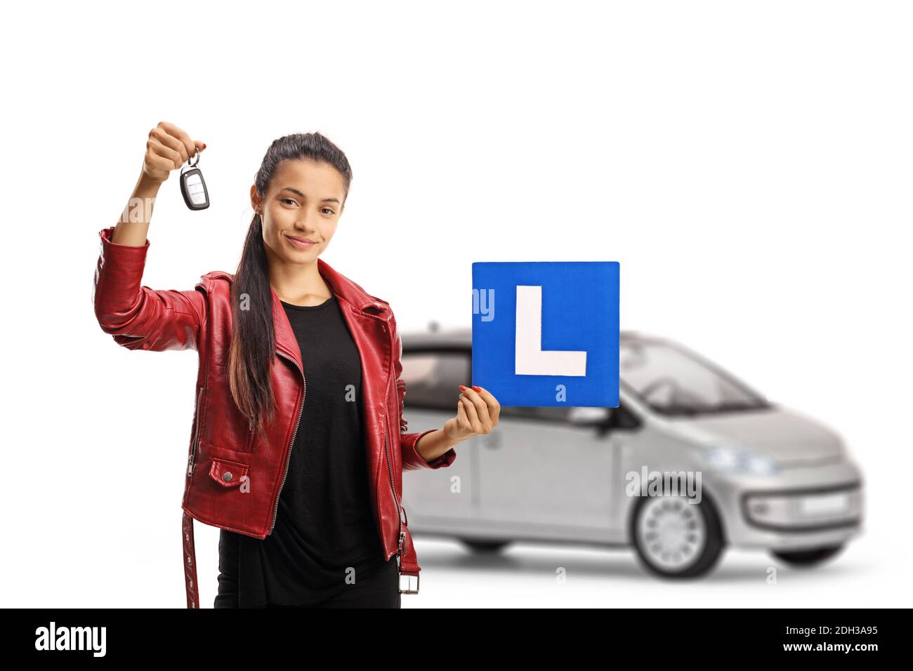 Female driver with a urban car holding a key and a learner plate ...