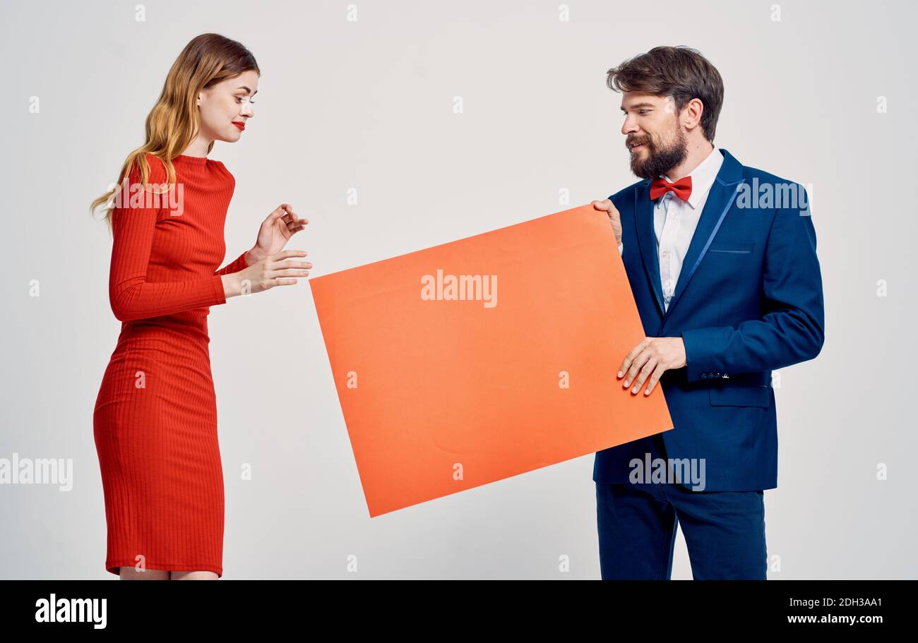 energetic man with mockup and emotional woman on a light background ...