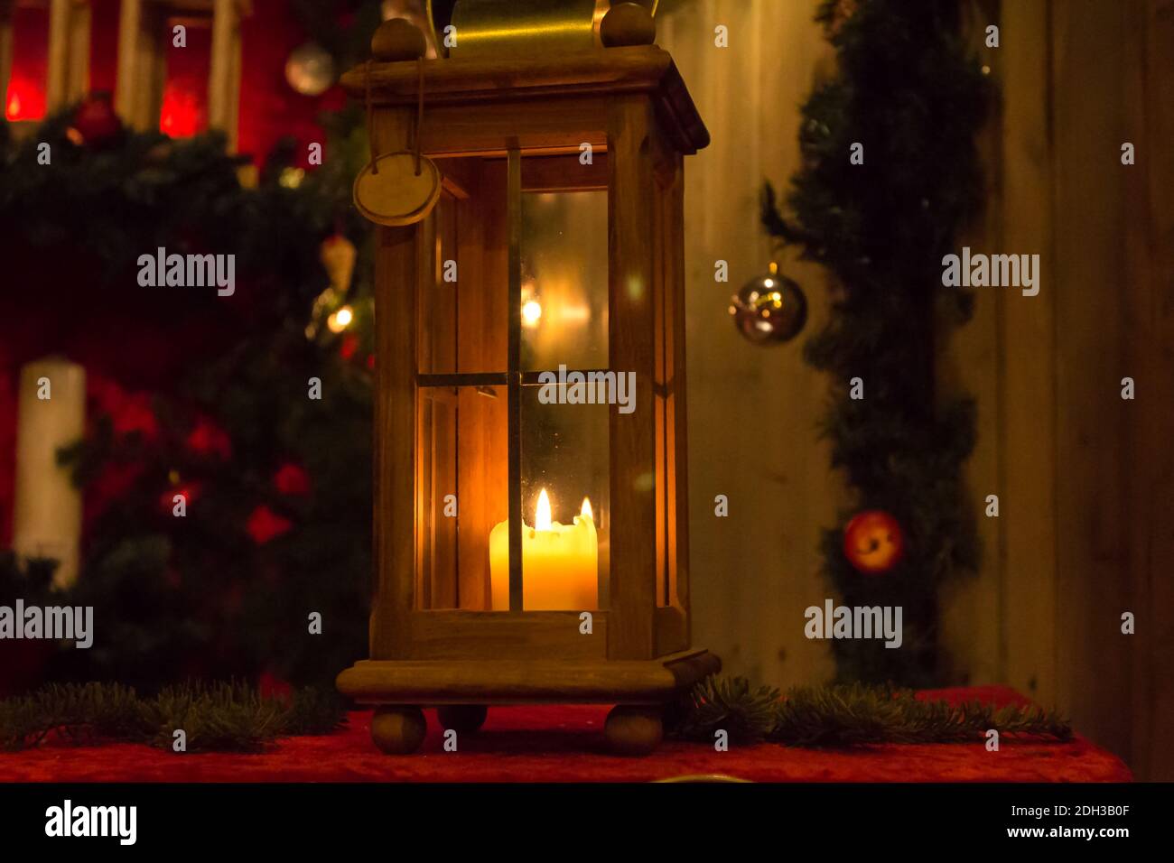 A closeup of a decorative Christmas wooden lantern with a candle ...