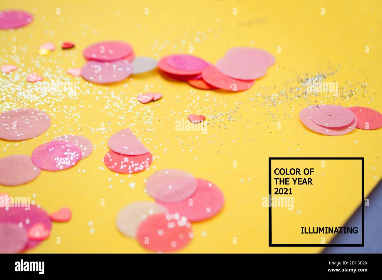 Colorful confetti, sparkles on bright yellow illuminating background ...