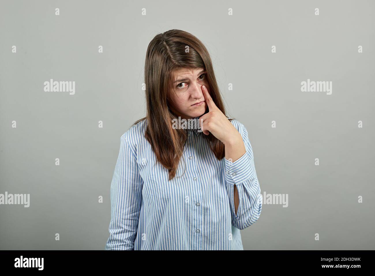 Contact lens on index finger, pointing to eye with hand, thinking ...