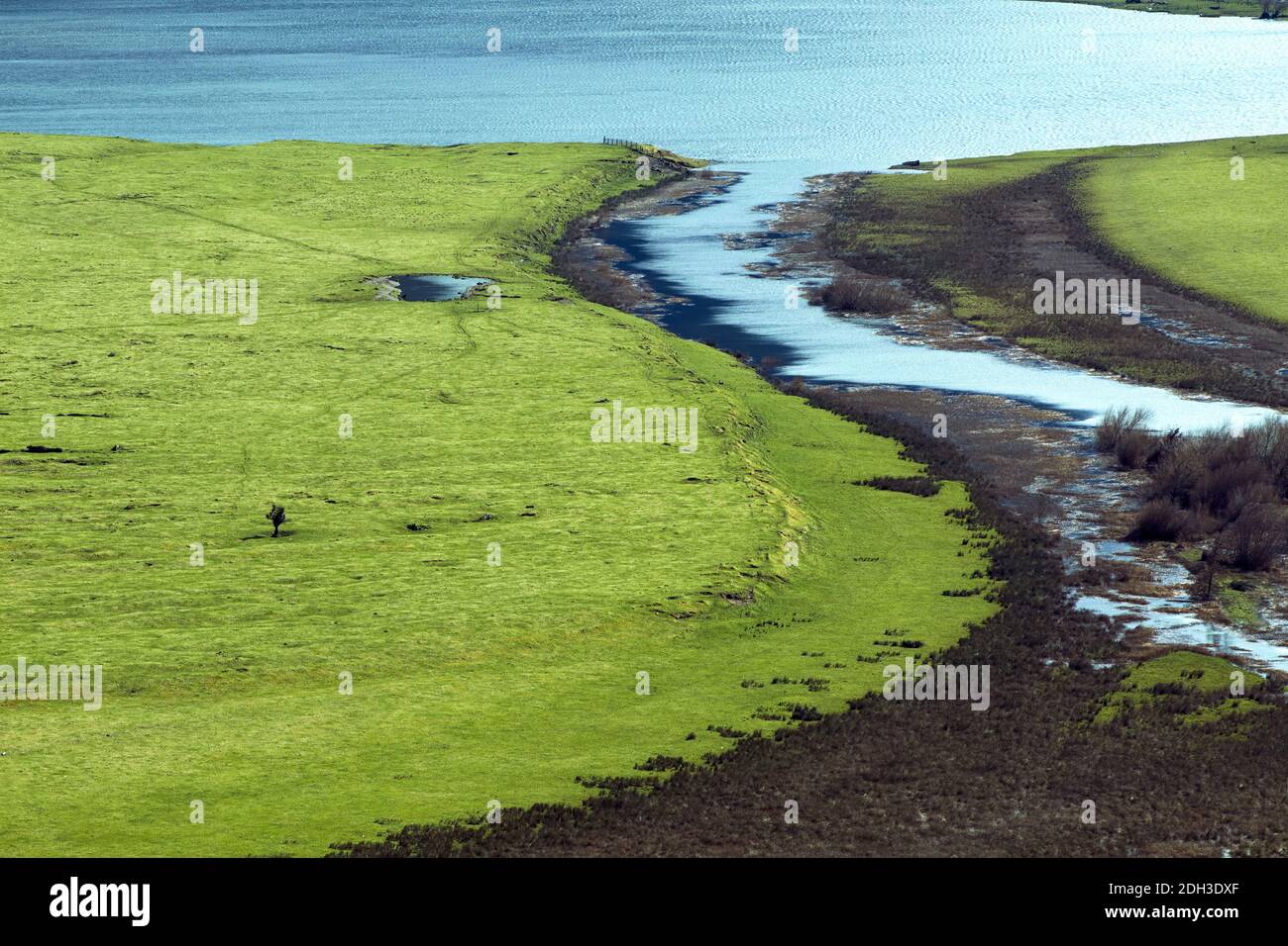 A small and calm stream flowing in the meadow ending in the river Stock ...