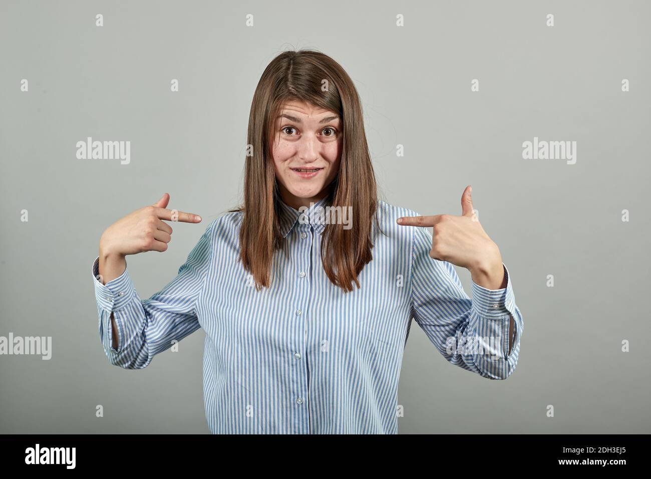 Pointing with hand at chest and staring. Shocked facial expression ...