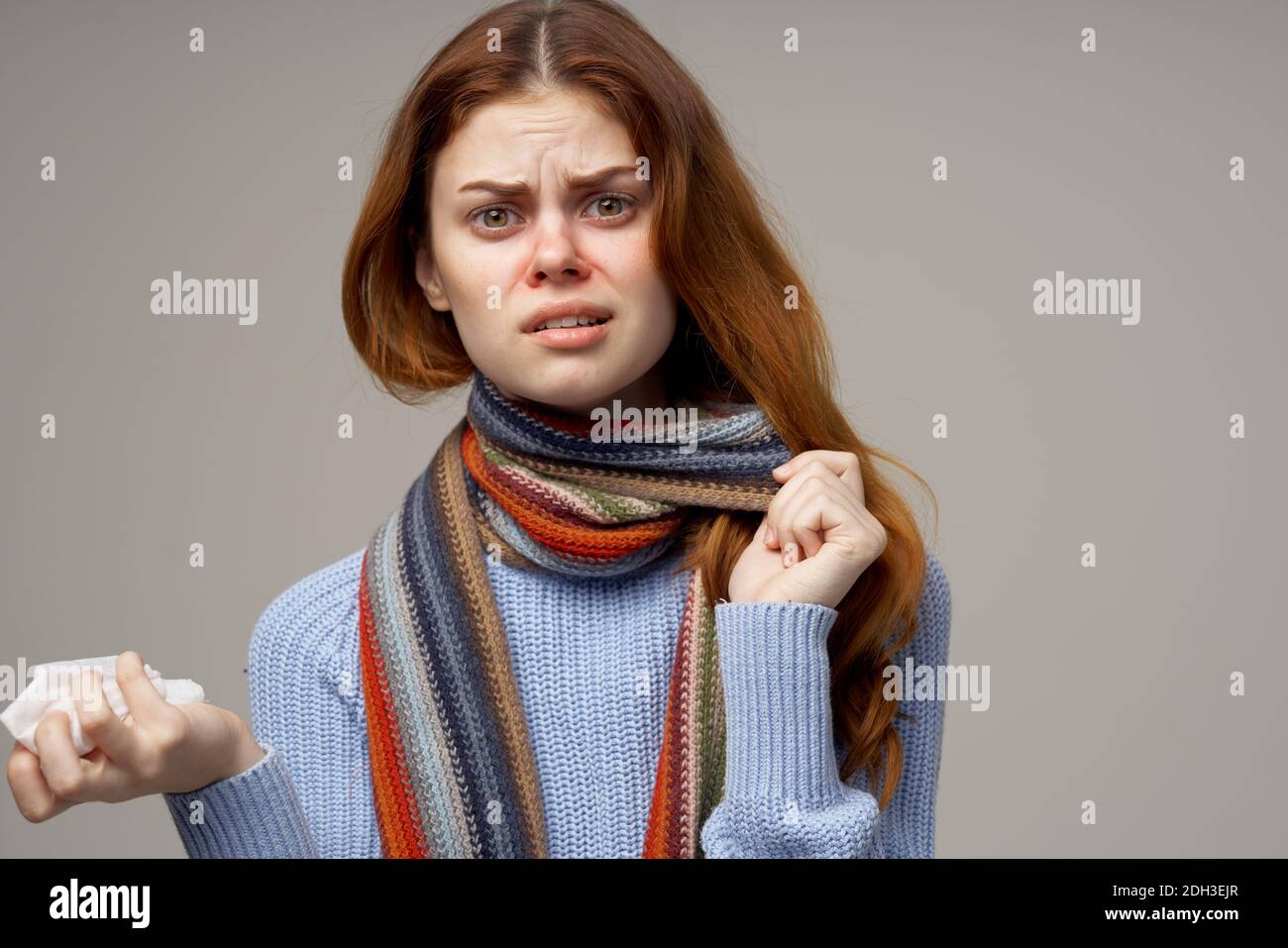 red-haired woman napkin in hand runny nose scarf sweater model Stock ...