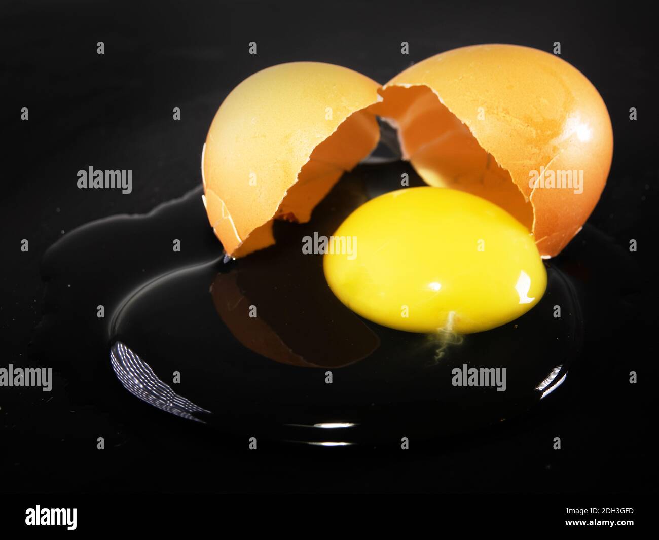 Eggshell is broken and the contents of egg flowed out Stock Photo - Alamy