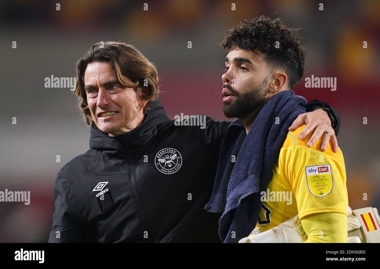 Brentford manager Thomas Frank (left) greets goalkeeper David Raya ...
