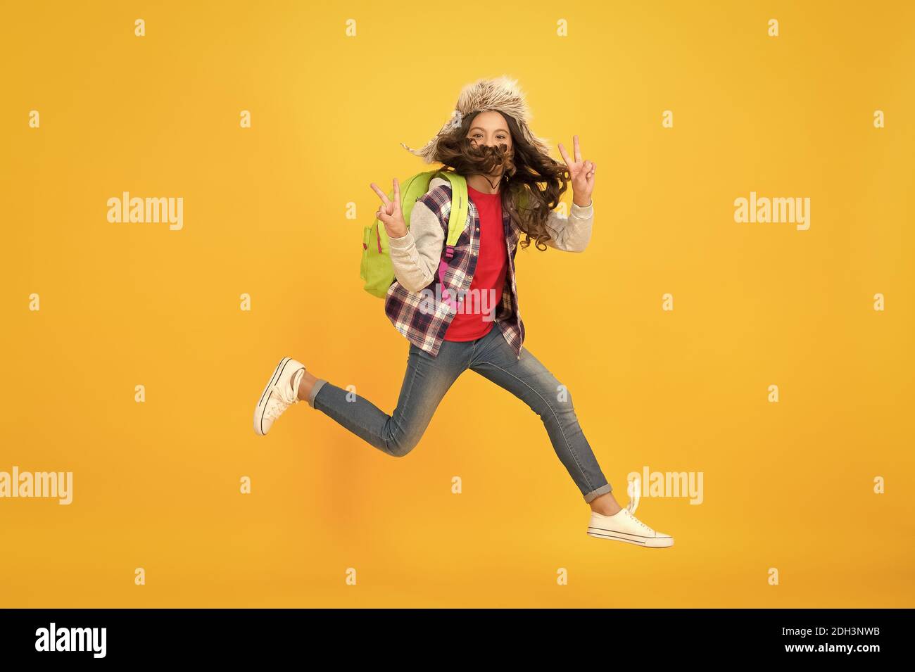 Leaping in air. Energetic little child in motion yellow background ...