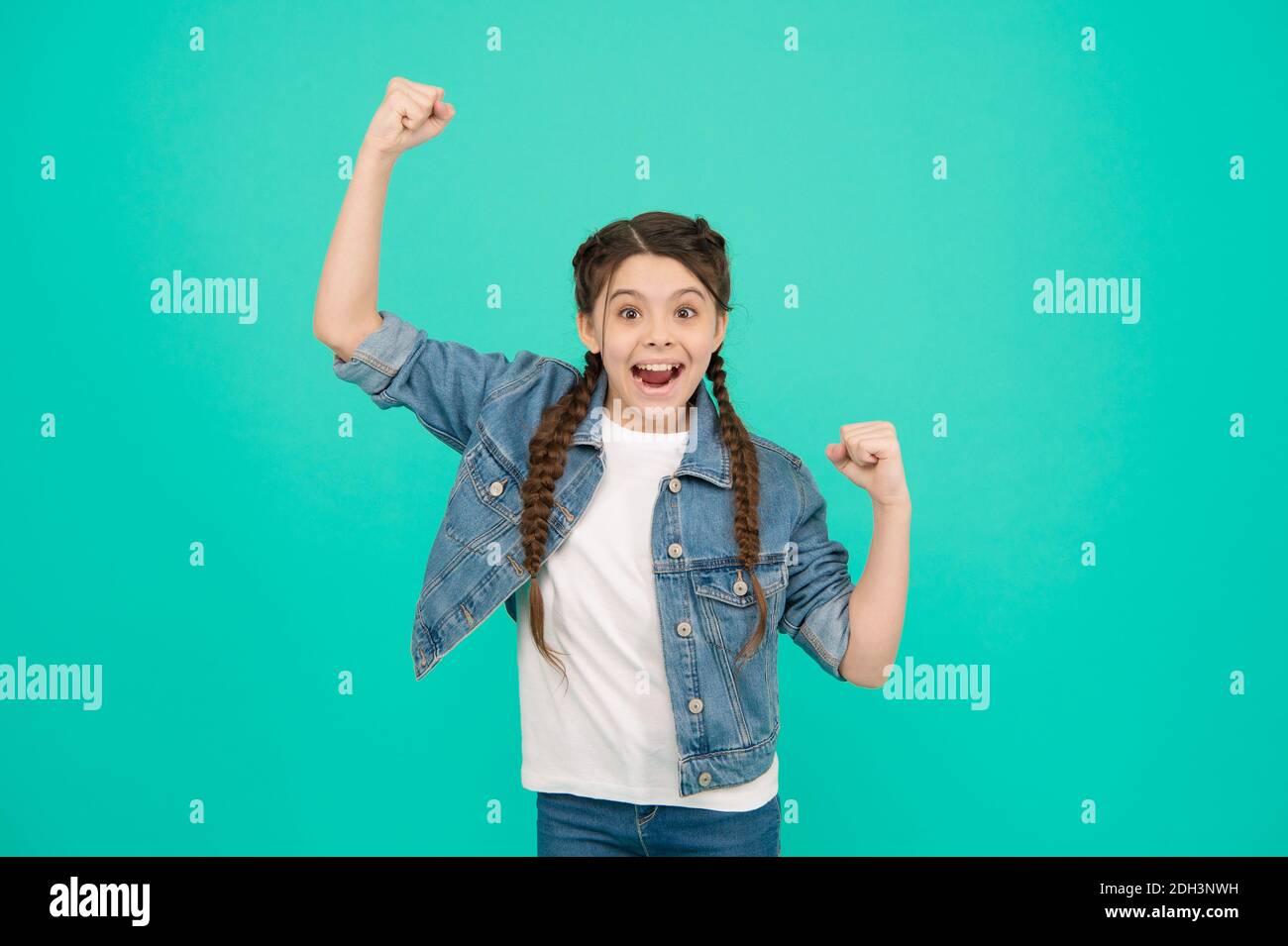 Happy child celebrate victory making winning gesture keeping fists ...