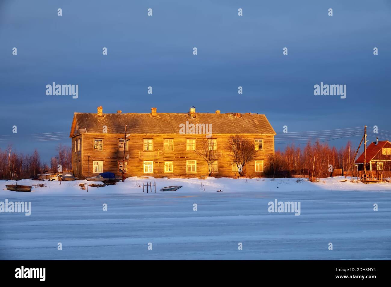 Two-storey log houses on banks of Northern river Stock Photo - Alamy