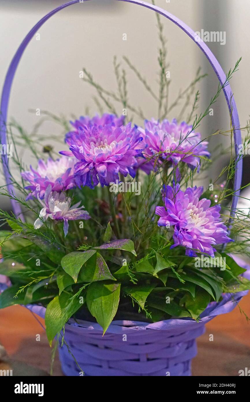 Purple flowers in small basket gift set Stock Photo - Alamy