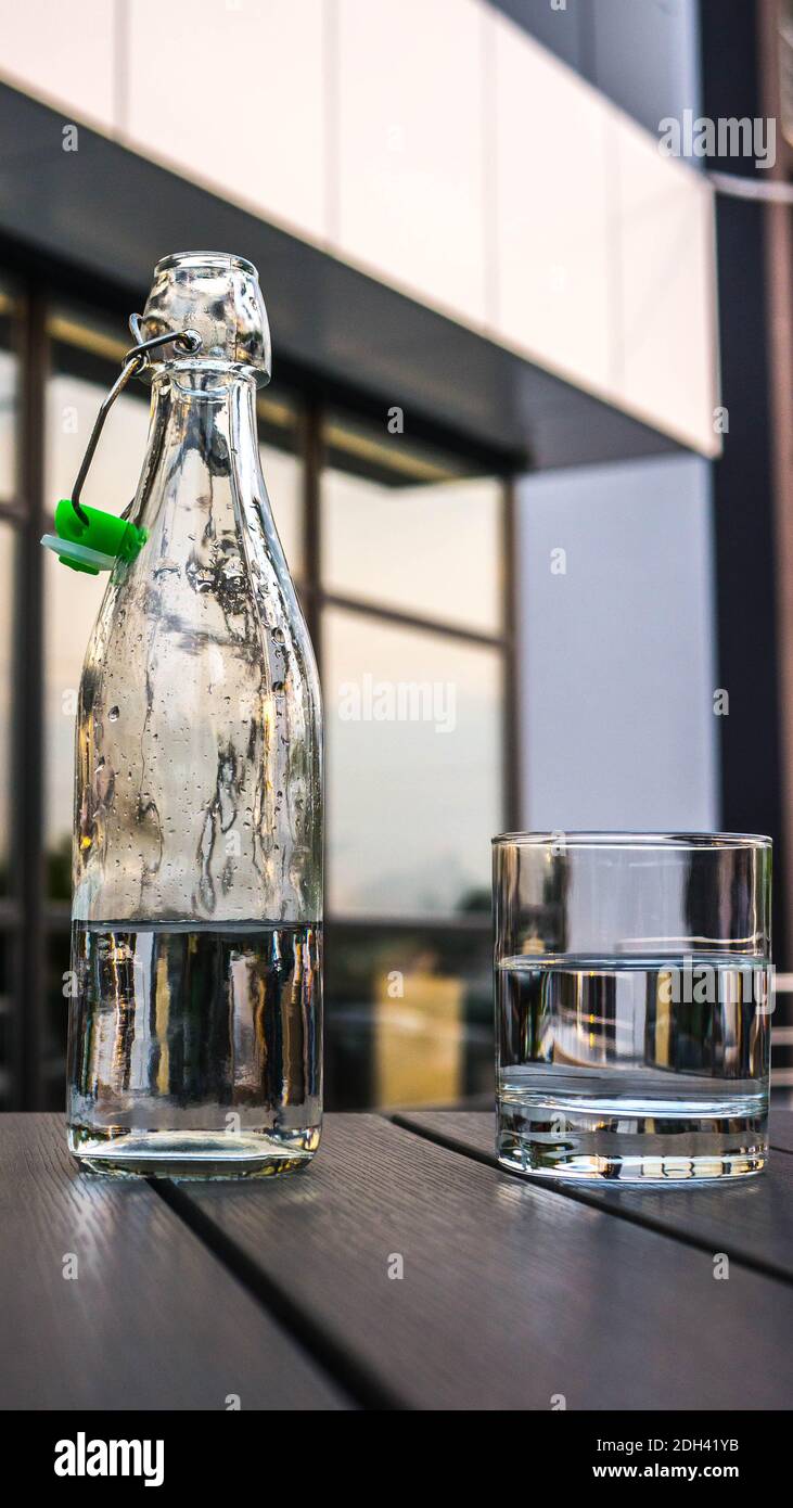 Mineral water in a glass bottle and glass,drinking water in a bar in a ...