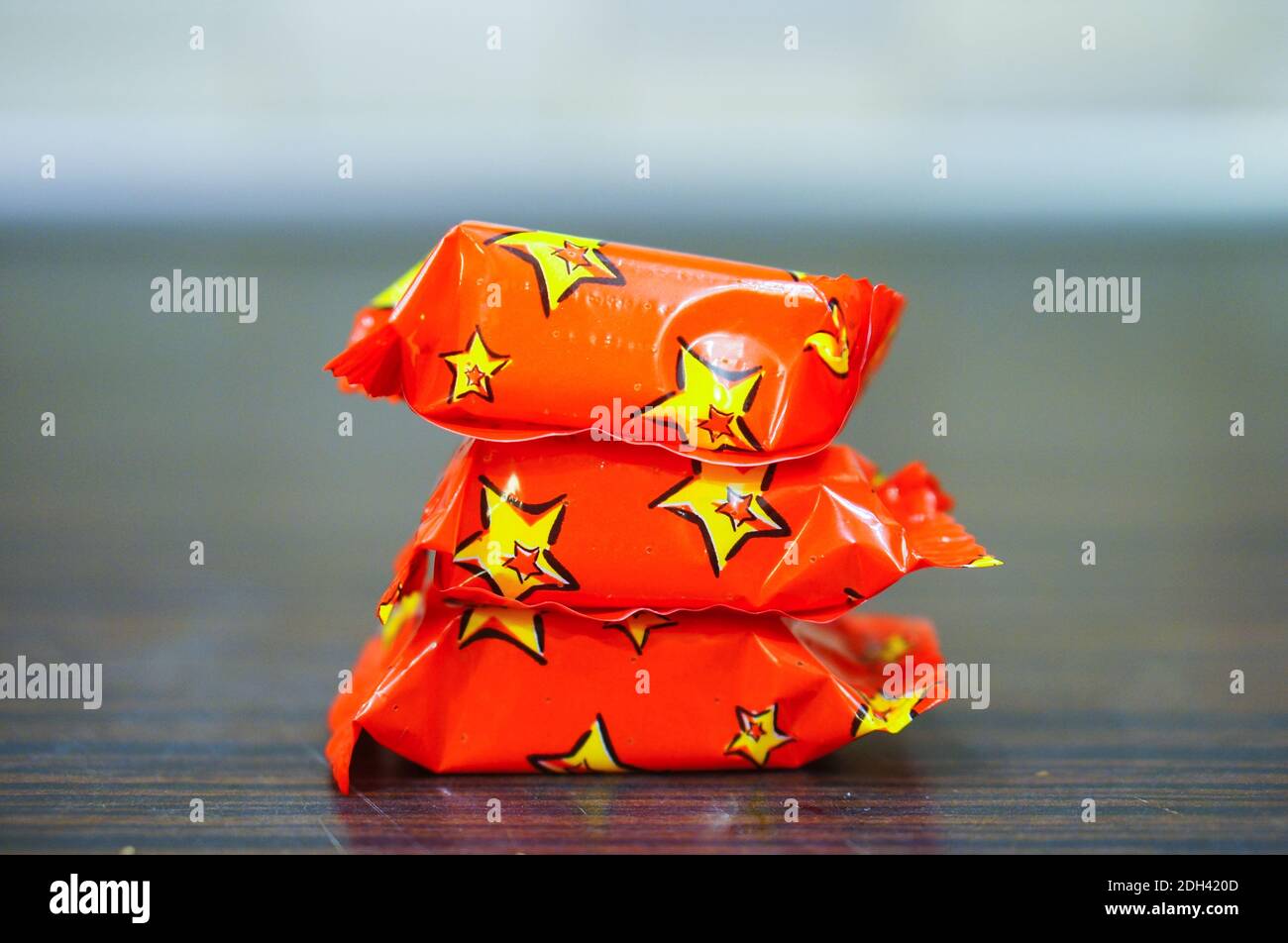 The stack of candy wrapped in red paper Stock Photo - Alamy