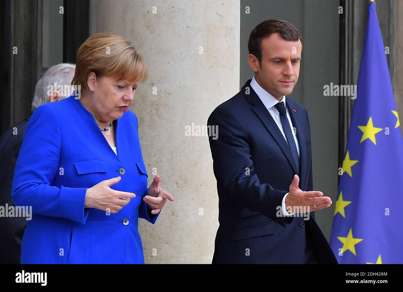 German Chancellor Angela Merkel (L) walks beside French President ...