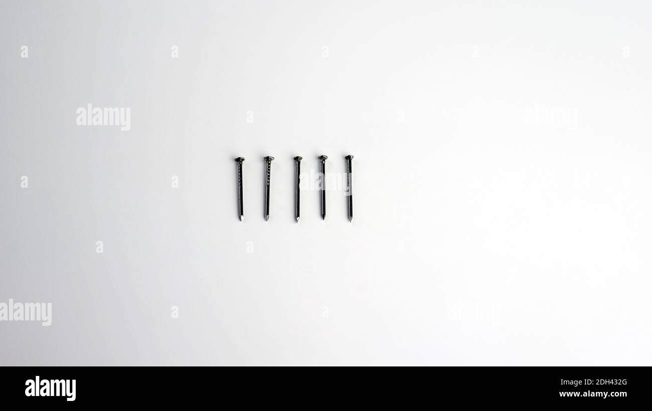 Set of mini nails top view on a white background Stock Photo - Alamy