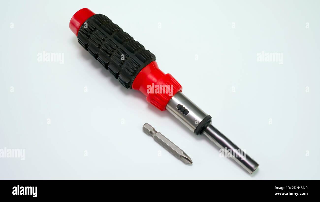 Reversible screwdriver with nozzle. On a white background. Universal ...