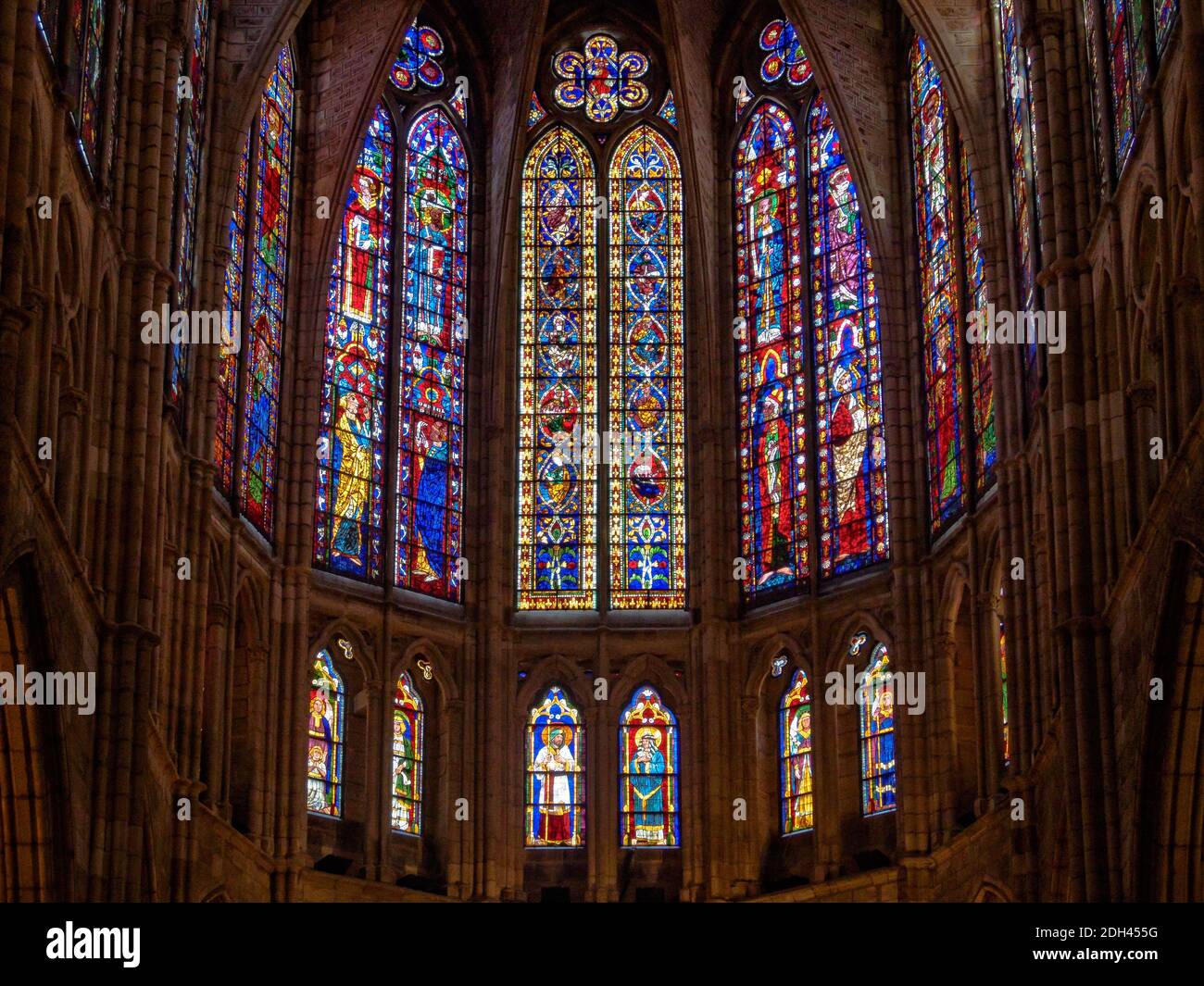 Stained glass windows above the main altar in the semicircular apse of ...
