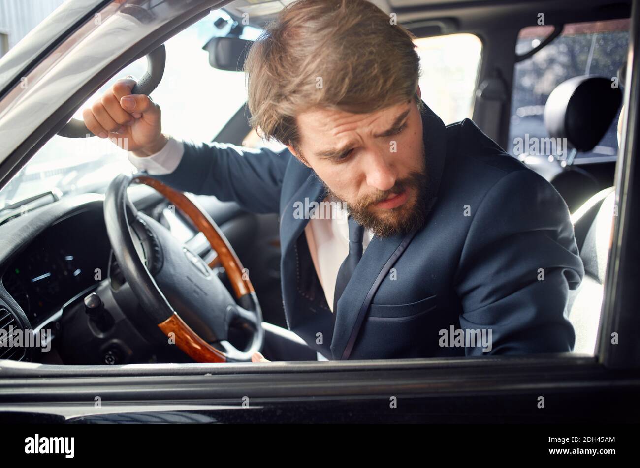 business man in a suit driving a car trip emotions official Stock Photo ...