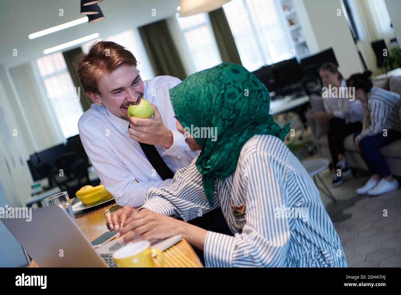 International multicultural business team working together on laptop ...