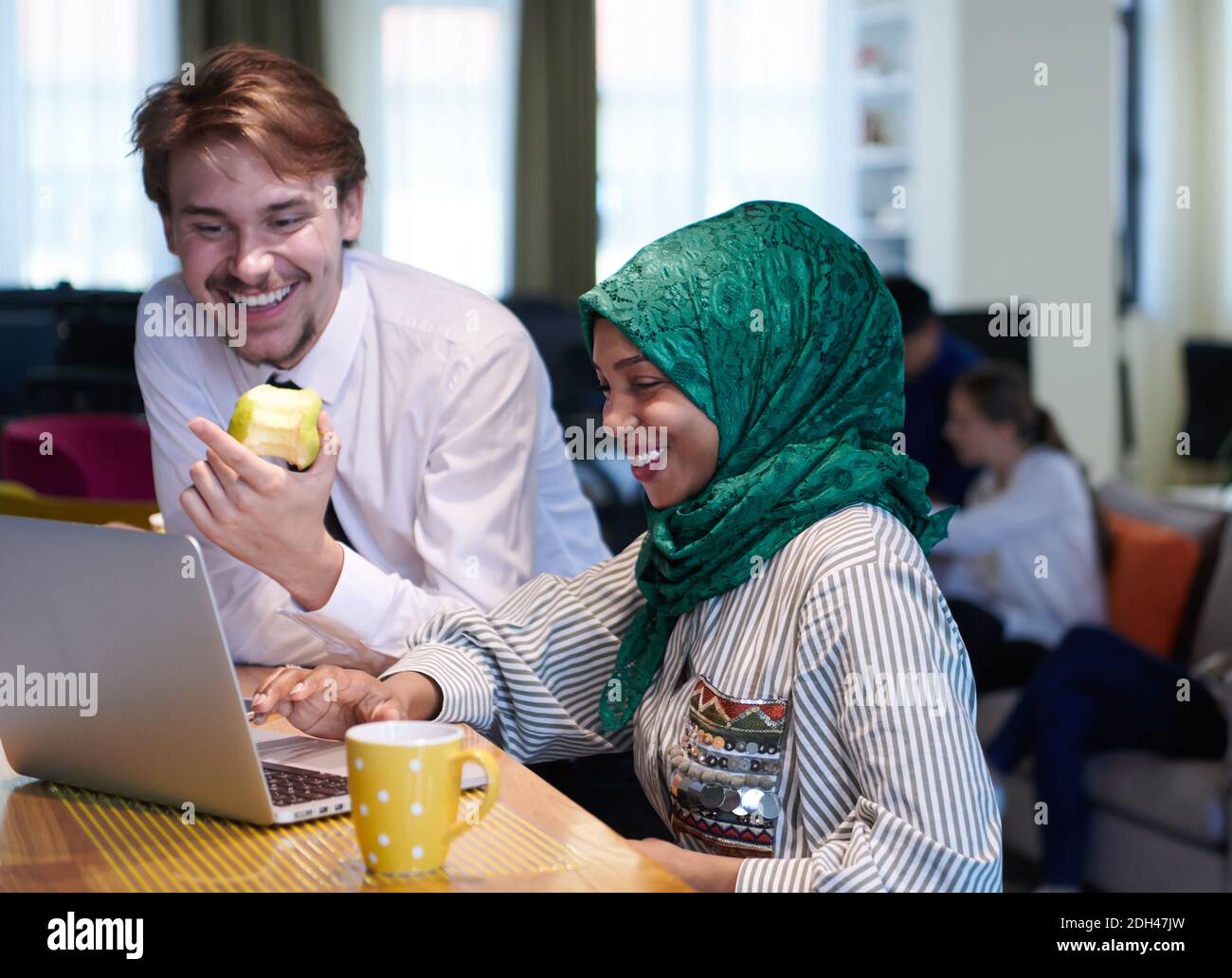 International multicultural business team working together on laptop ...