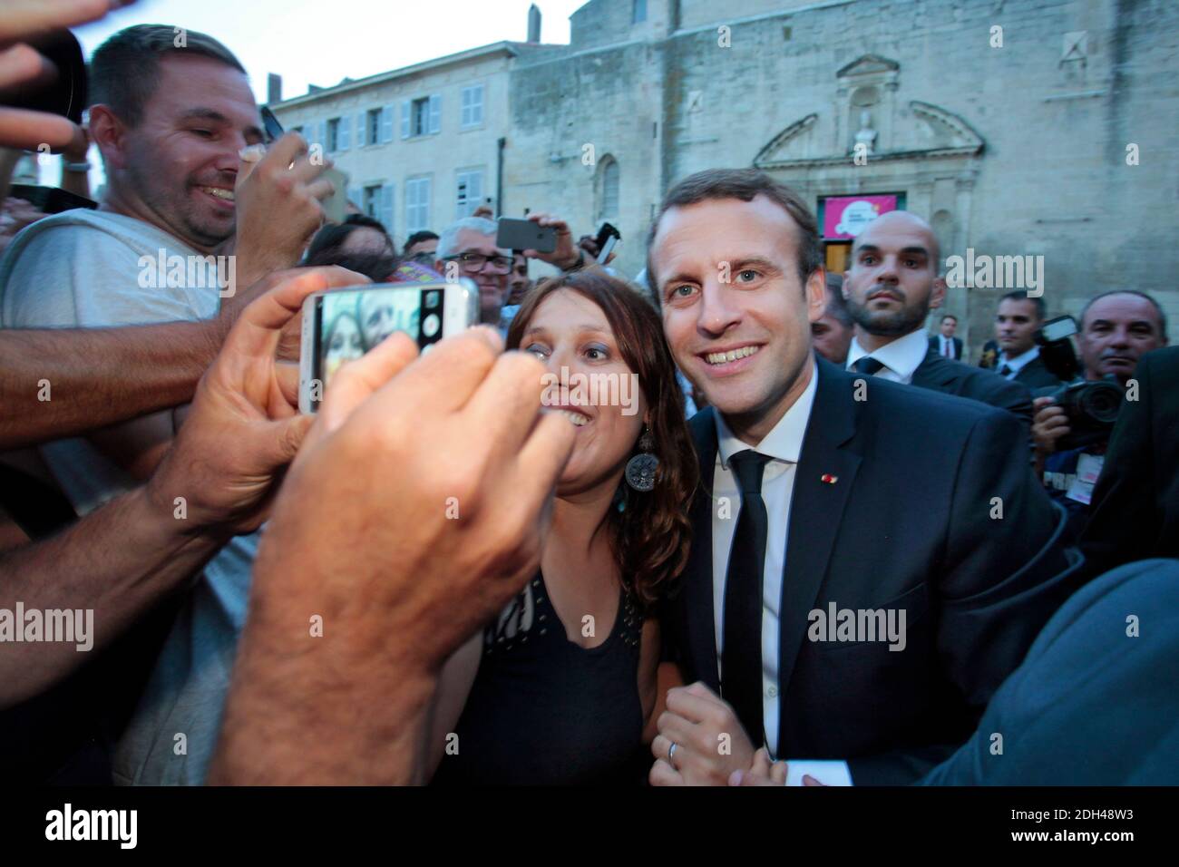 French President Emmanuel Macron shakes hand with residents during a ...