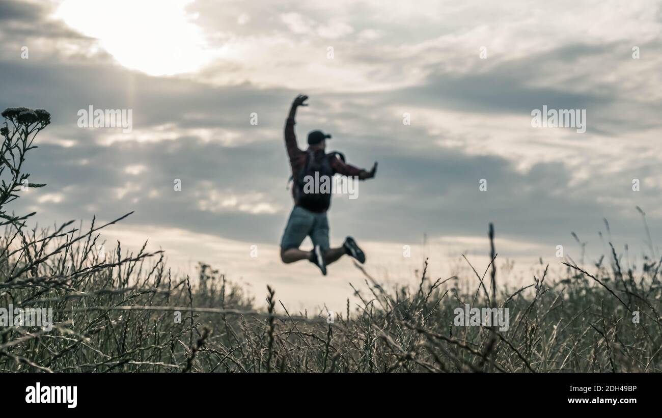 A guy in a jump in nature, a happy man jumped off, a young man in ...