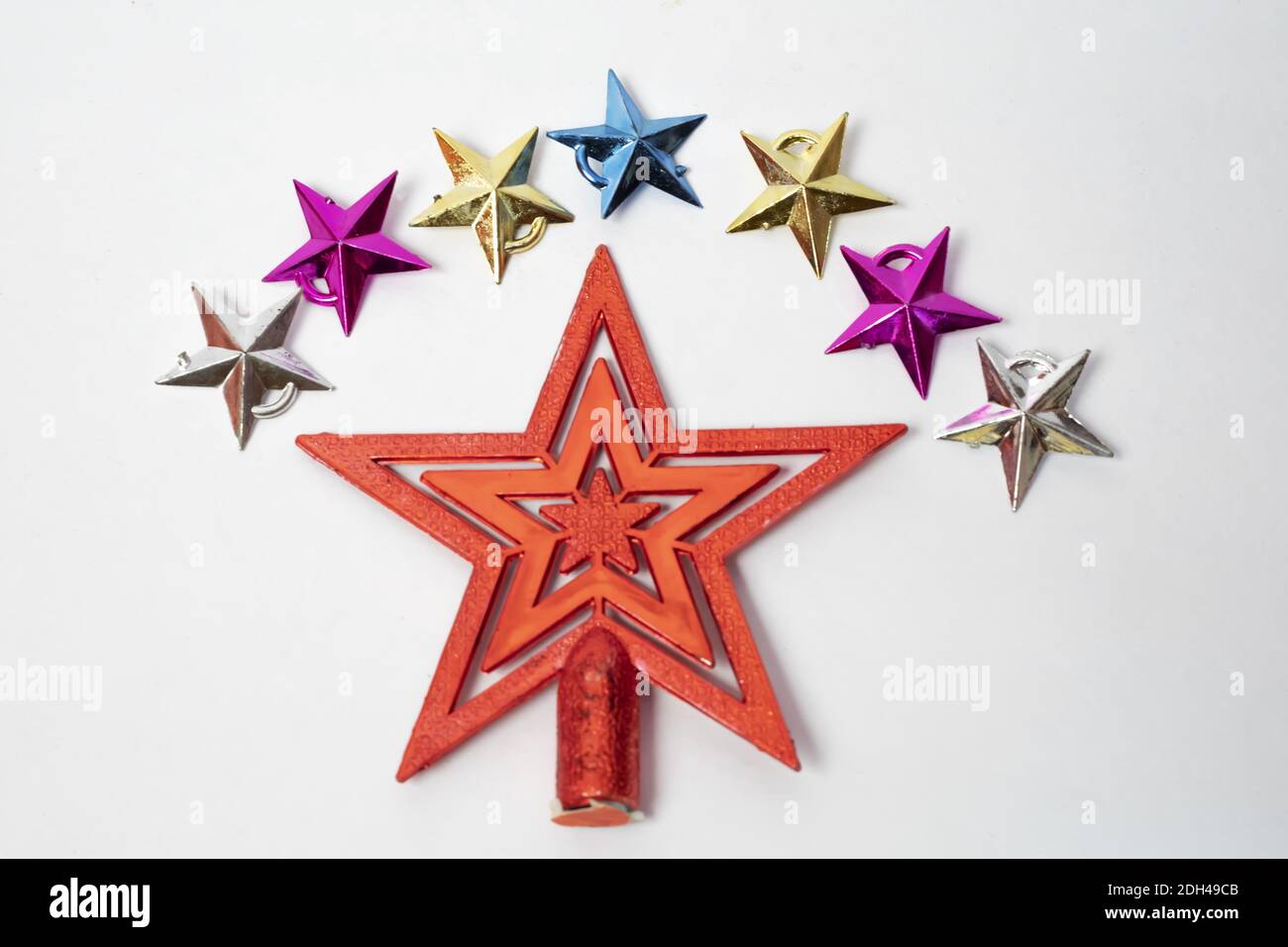 A top view of colorful Christmas star ornaments with a big red star on ...