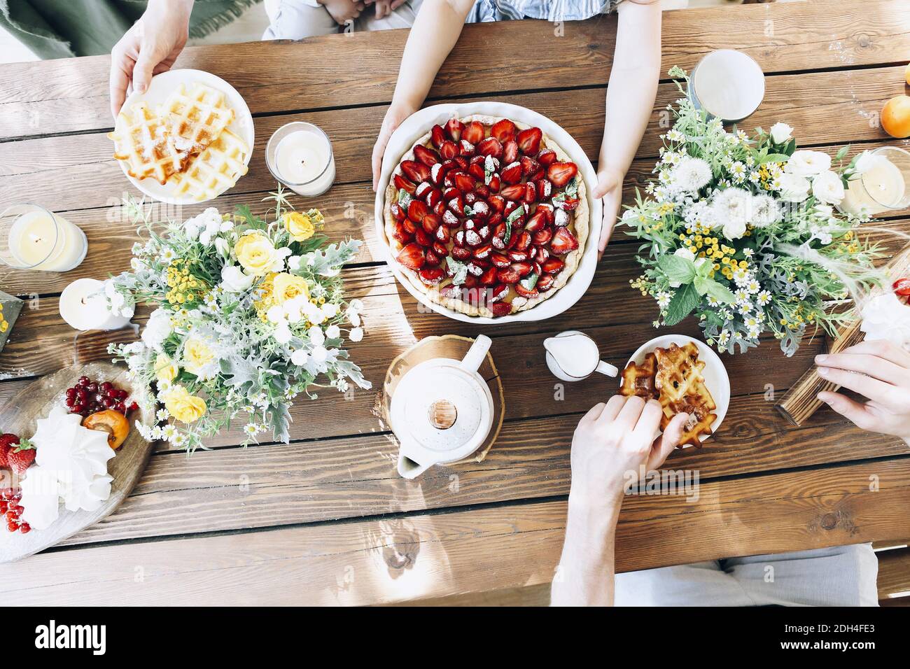 Crop family having tasty breakfast Stock Photo - Alamy