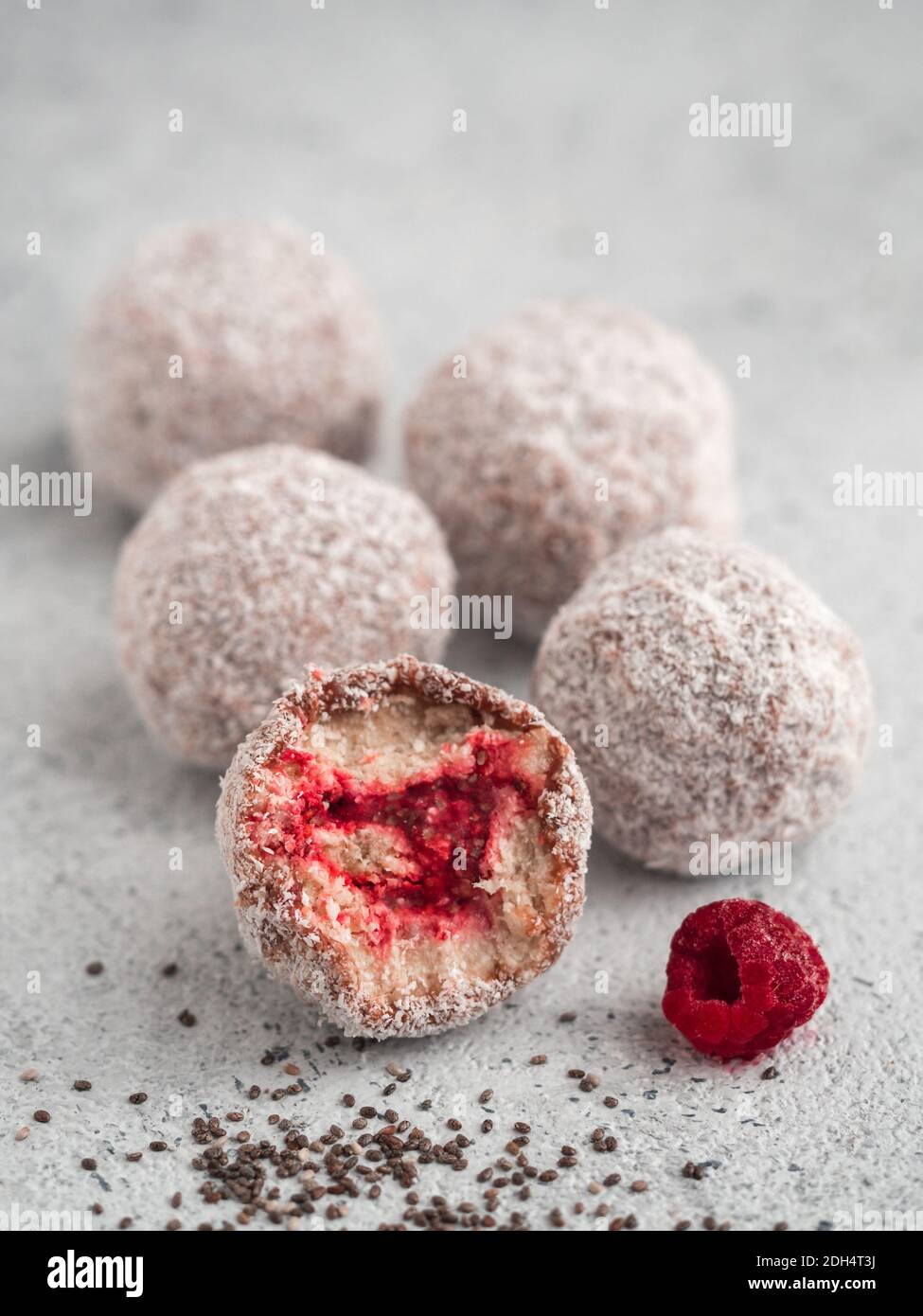 Raw lamington bliss balls with raspberries chia jam Stock Photo - Alamy