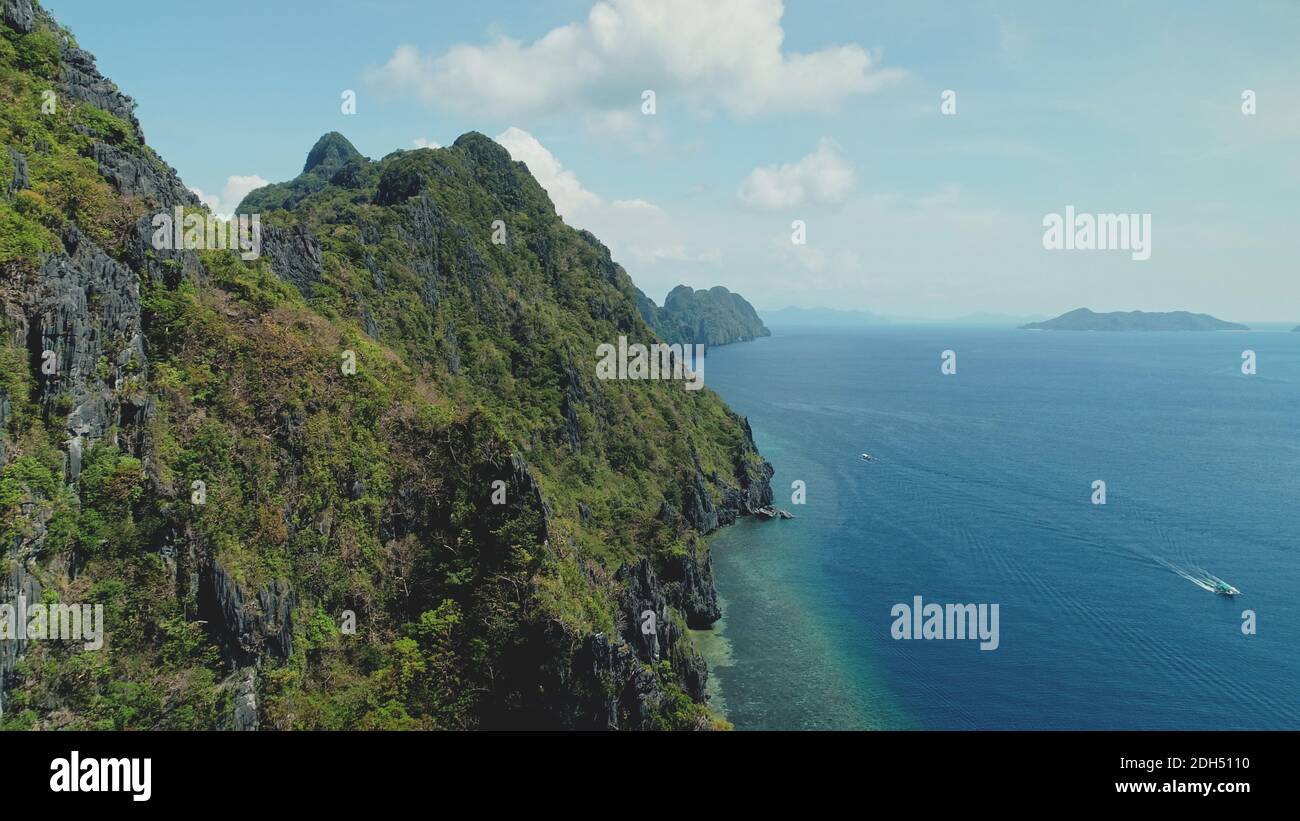 Aerial landscape of ocean bay greenery cliff shore at sand beach. Boats ...