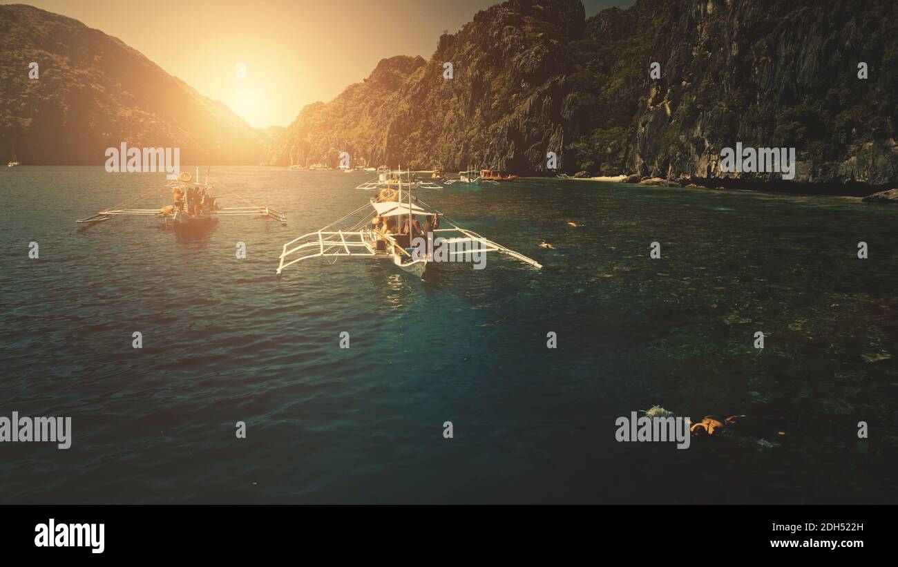 Sunset at closeup passenger boats at cliff ocean shore aerial view ...