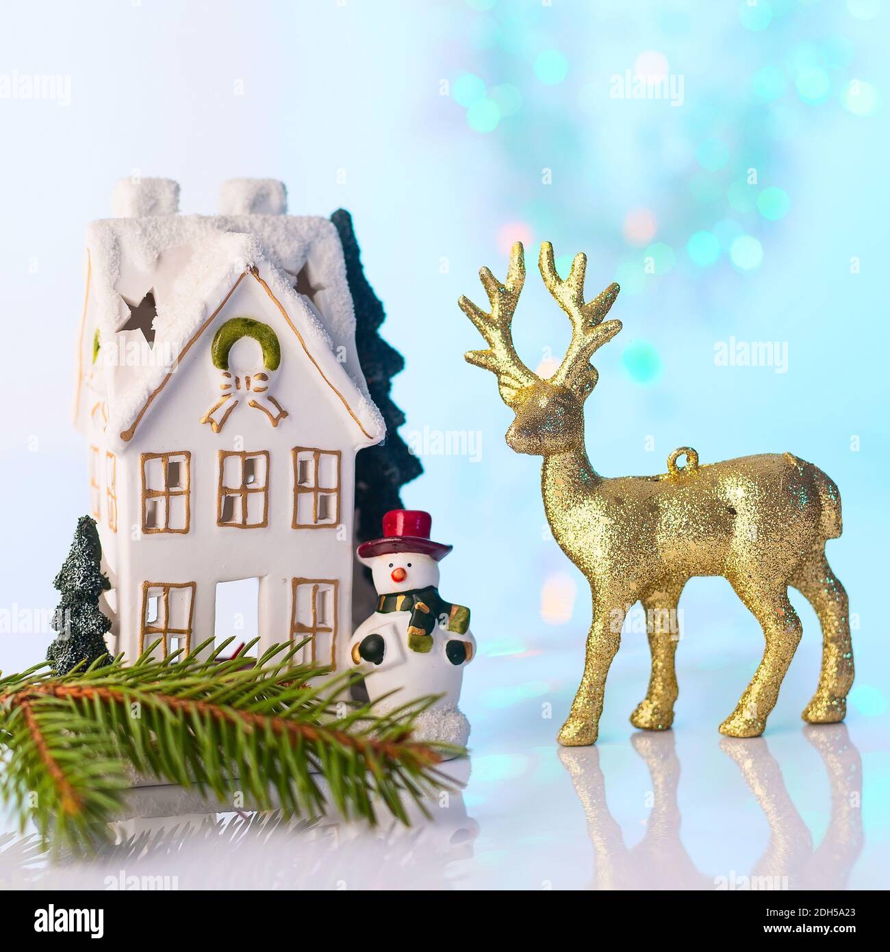 Christmas house and reindeer with bokeh lights Stock Photo - Alamy
