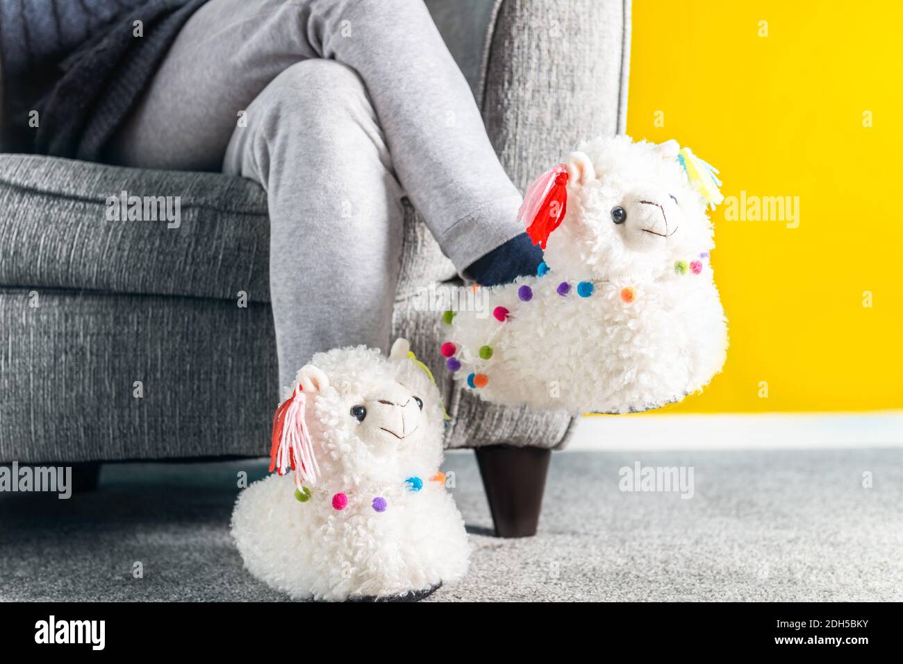 Young girl in cute soft 3d llama slippers Stock Photo - Alamy