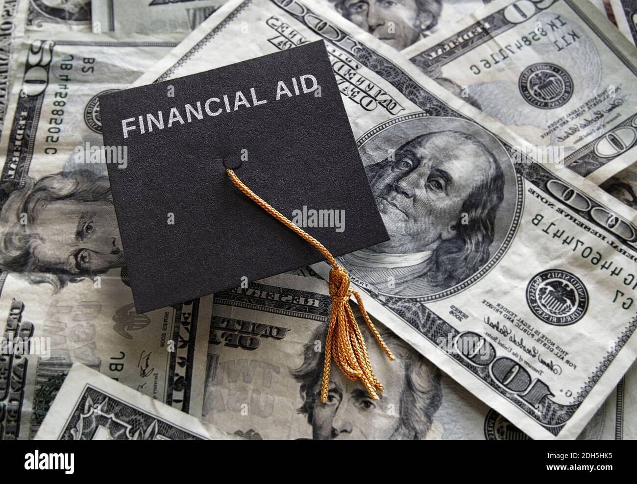 Graduation cap with Financial Aid text, on assorted money Stock Photo ...