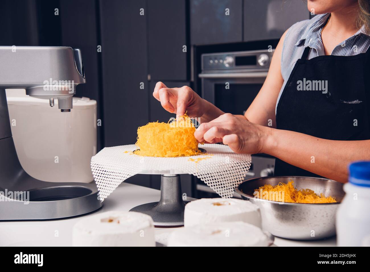 Female baker decorating birthday cake hi-res stock photography and ...