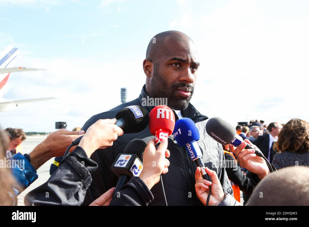 Teddy Riner speaks with media representatives after disembarking from ...